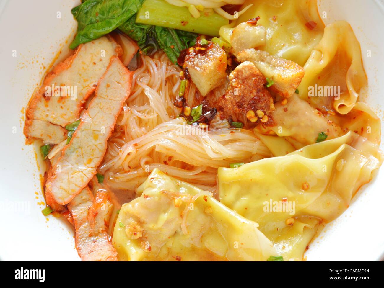 thin rice noodle topping dumpling and slice barbecue pork in soup Stock ...