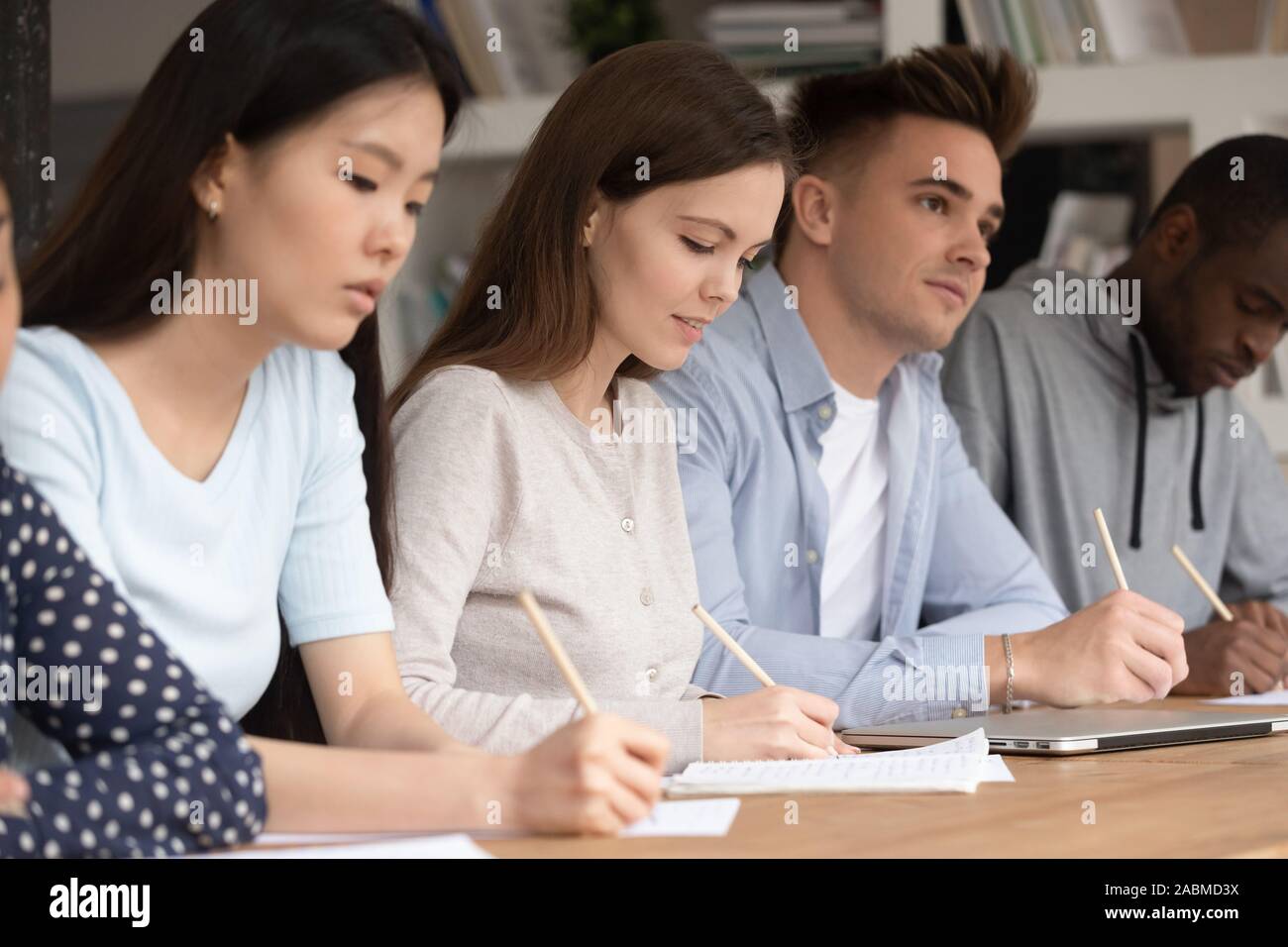 Happy concentrated mixed race students attending interesting lecture ...
