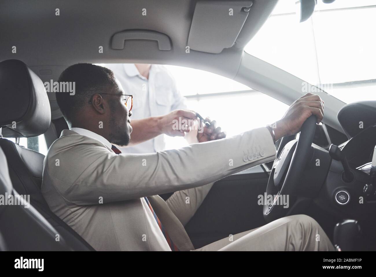 Young black businessman test drive new car. Rich african american man ...