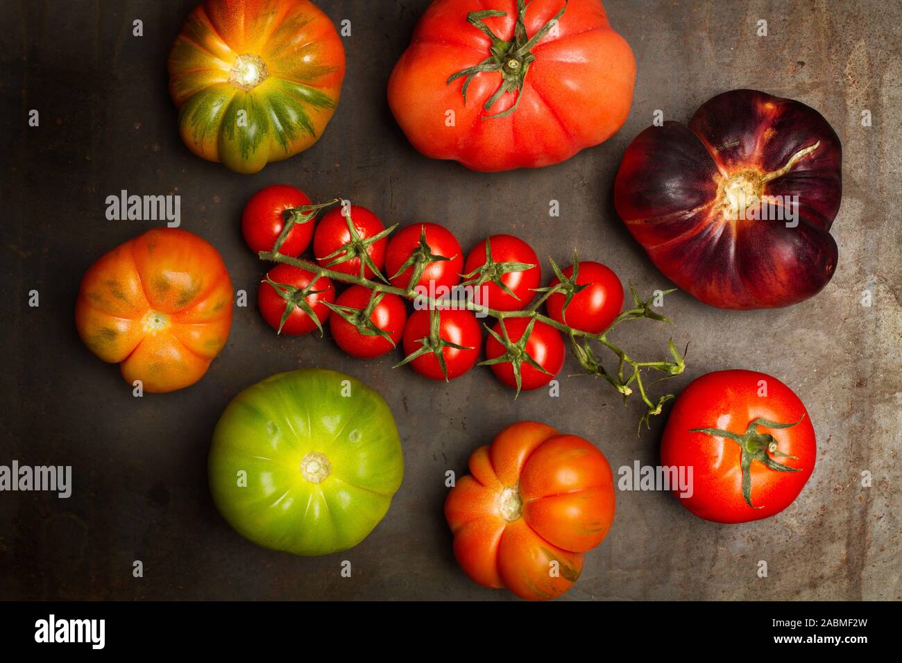 different types of tomatoes on a rusty metal table Stock Photo - Alamy