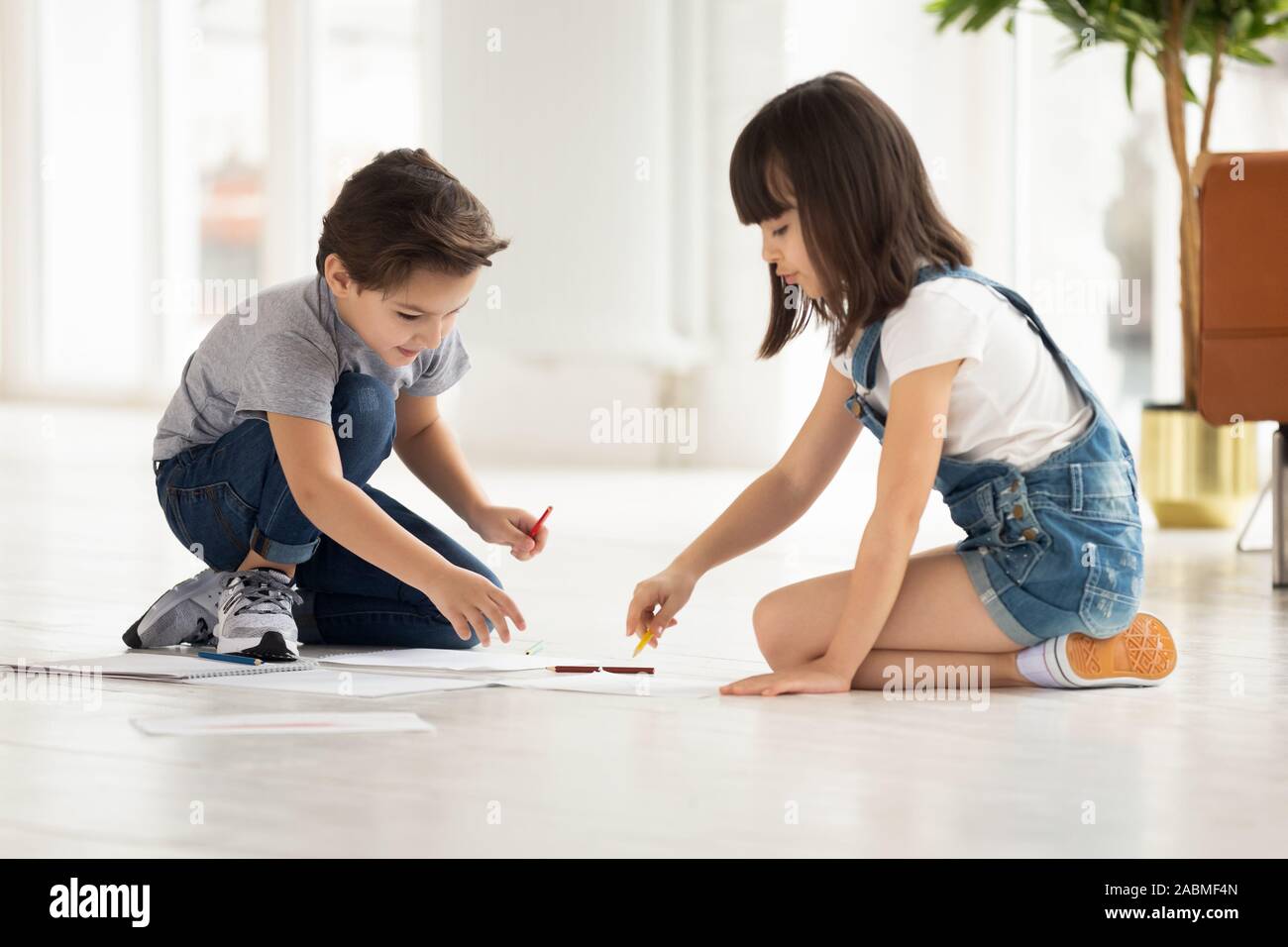 Little siblings play drawing at home floor together Stock Photo - Alamy