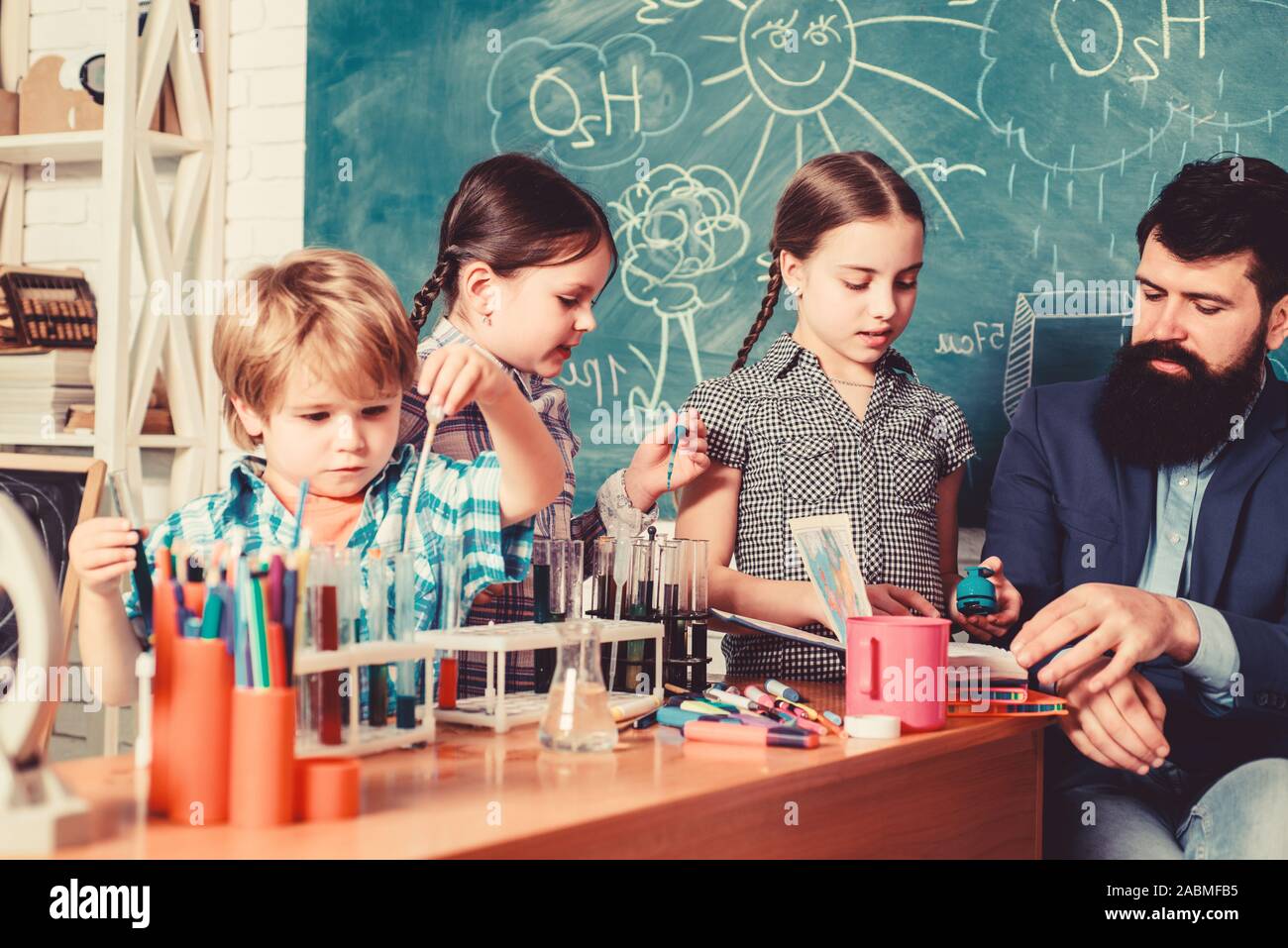 students doing science experiments with microscope in lab. school kids ...
