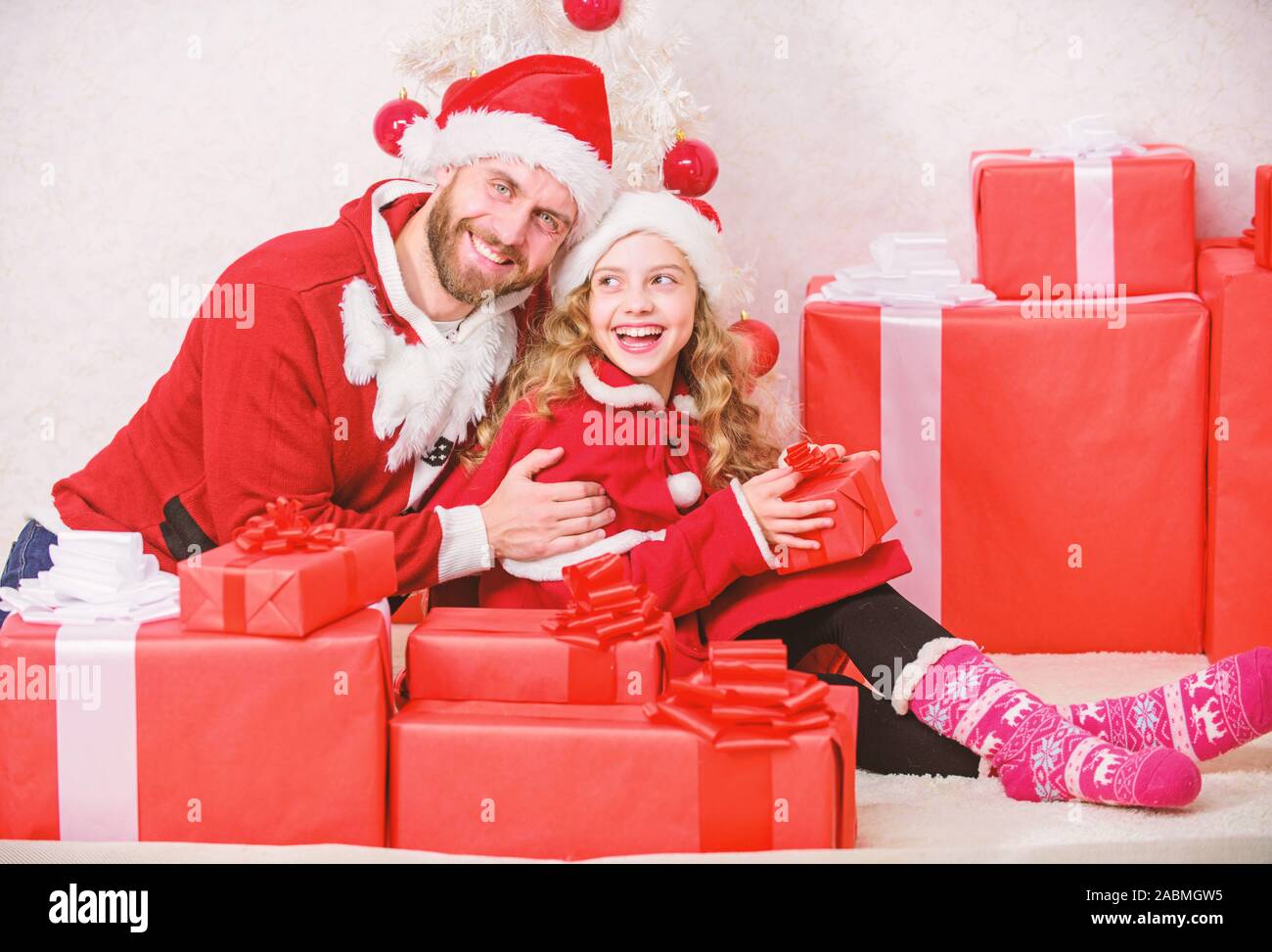 Christmas gift for child. Dad in santa costume give gift to daughter ...