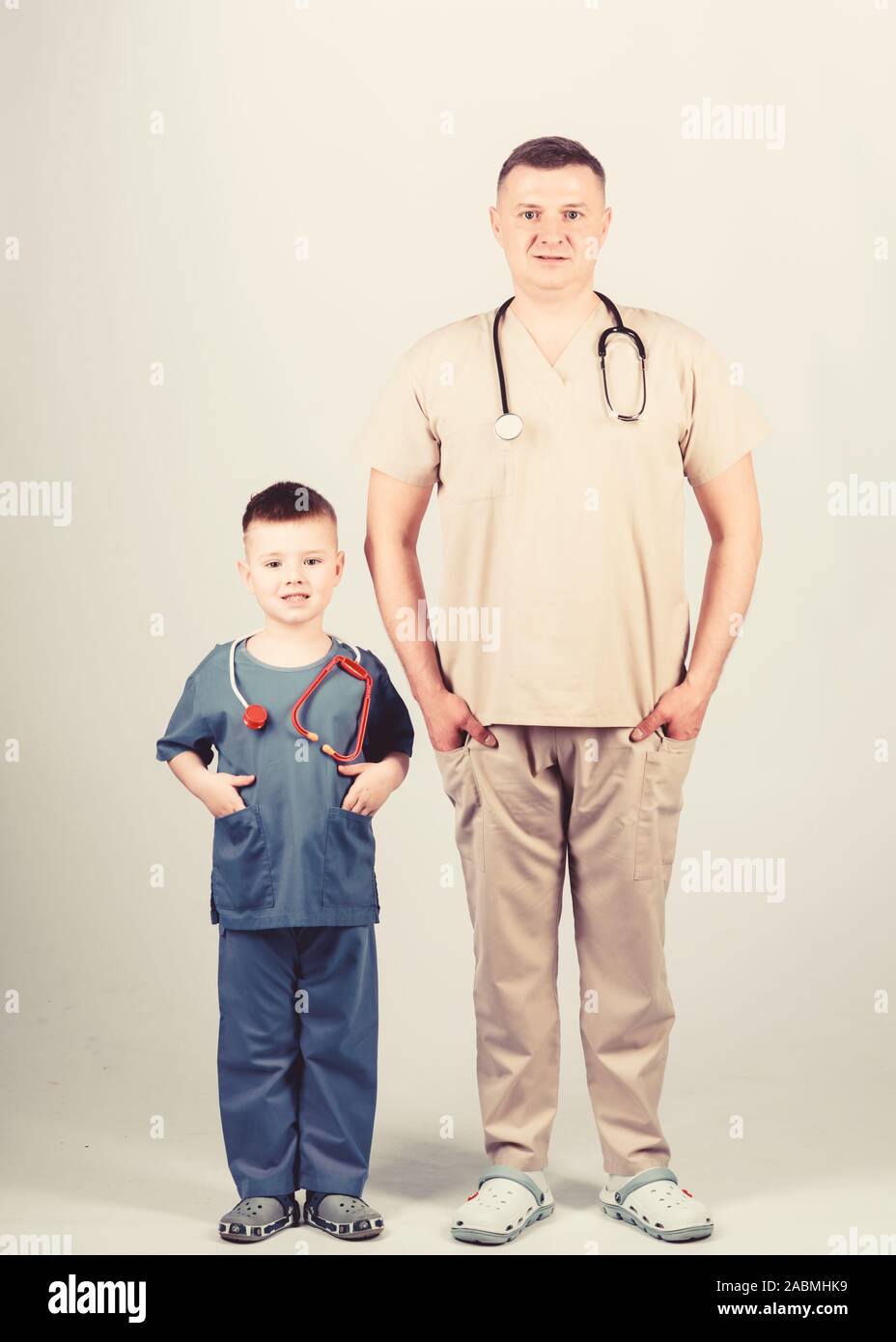 Father doctor with stethoscope and little son physician uniform. Future ...