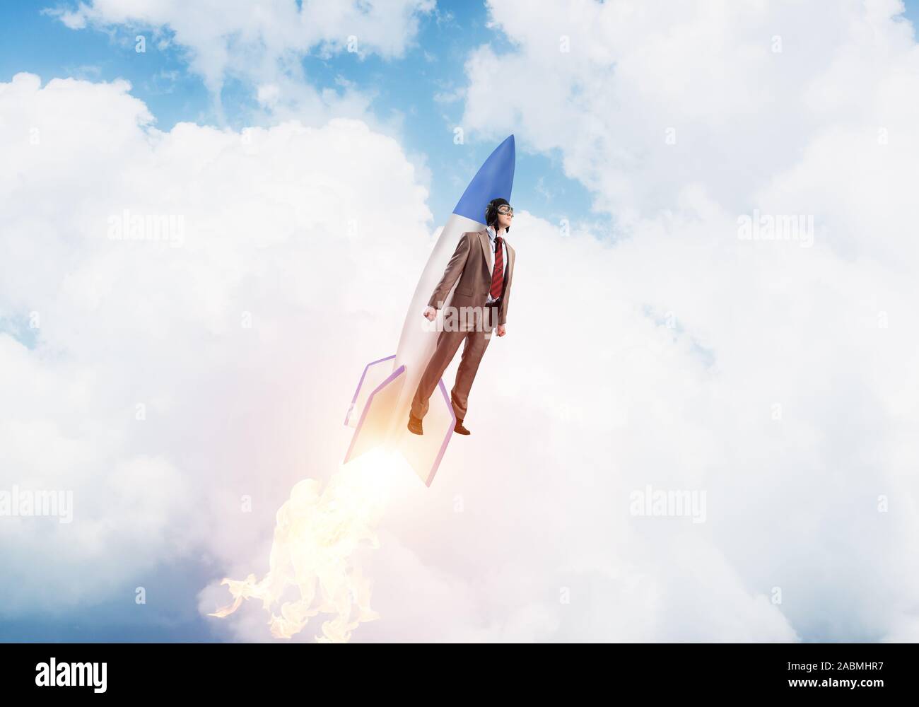 Business person in aviator hat flying on rocket Stock Photo - Alamy