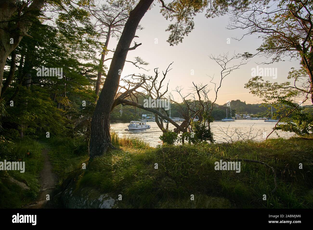 Dusk on Matsushima Bay, with boats floating in the distance, and a ...