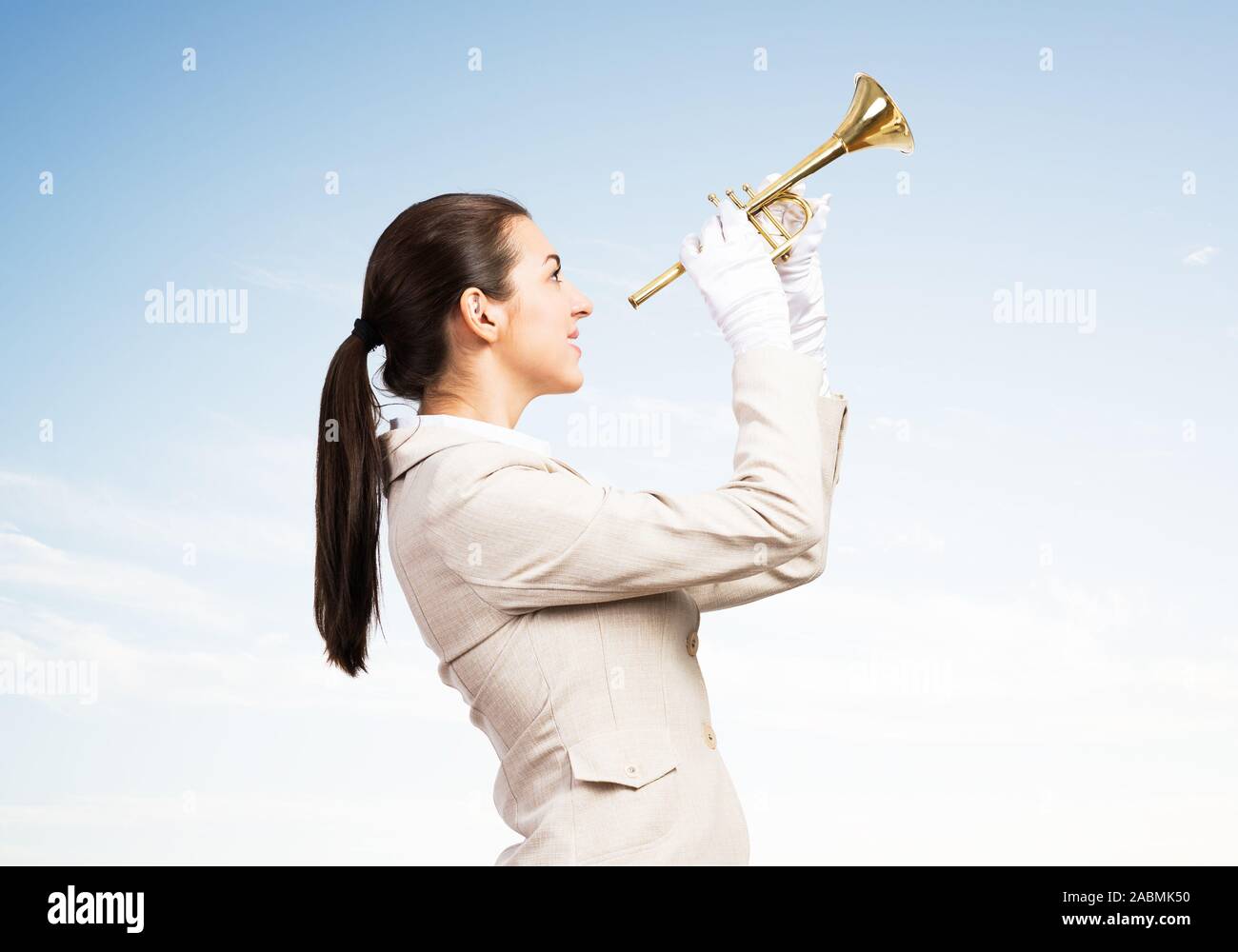 Beautiful woman playing trumpet brass Stock Photo - Alamy