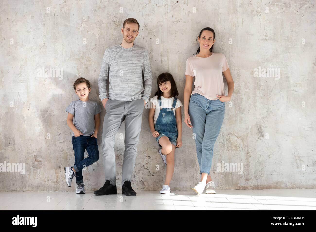 Portrait of happy young family with kids posing together Stock Photo ...