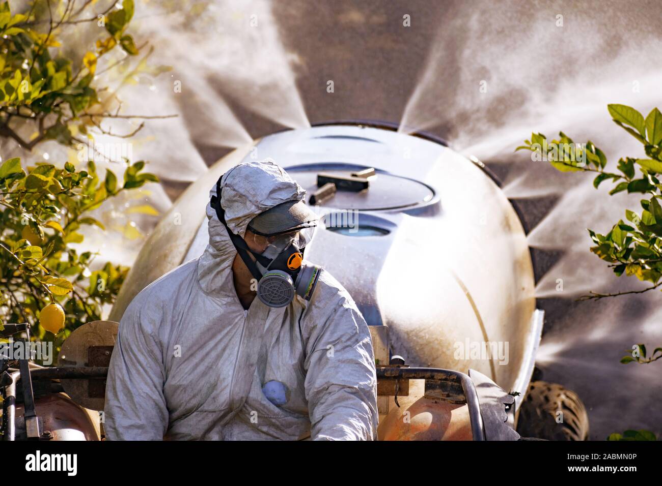 Top view of Tractor spraying pesticide and insecticide on lemon ...