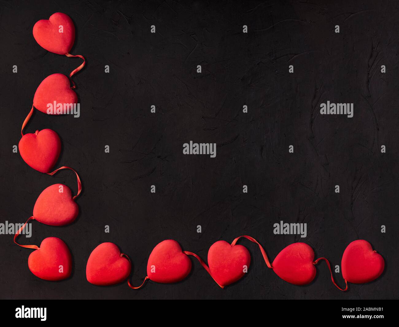 small hearts on a black background for valentines day Stock Photo - Alamy