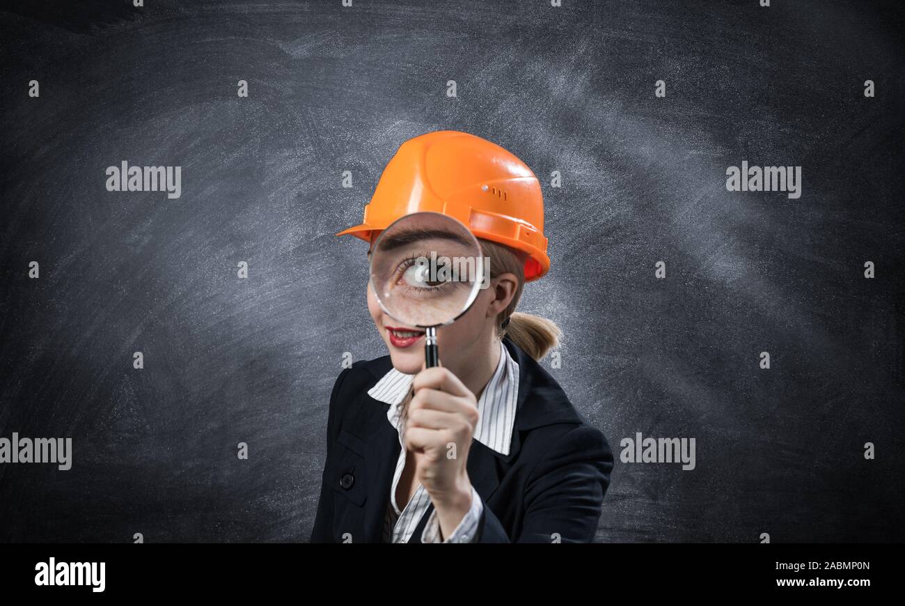 Technical inspector looking through magnifier Stock Photo - Alamy