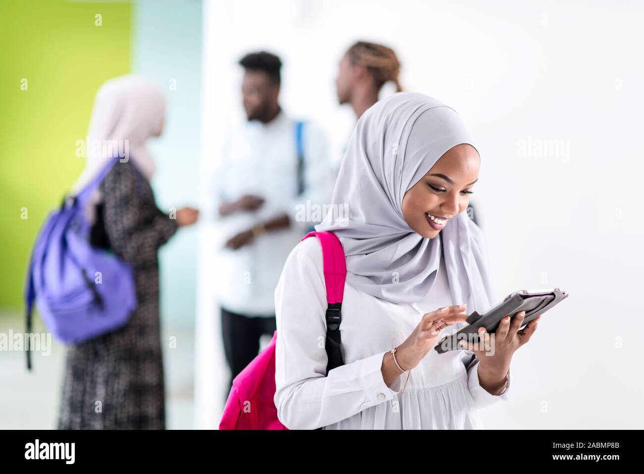 young modern muslim african female student using tablet computer with ...