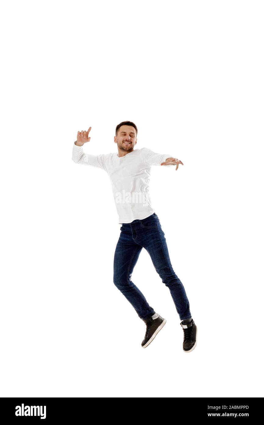 handsome young bearded man jumping. Full length portrait over white ...