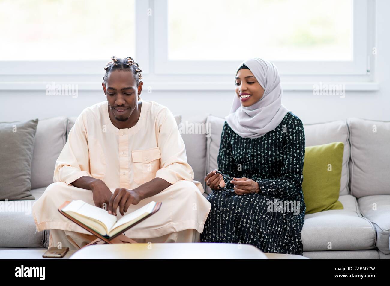 african muslim couple at home in ramadan reading quran holly islam book ...