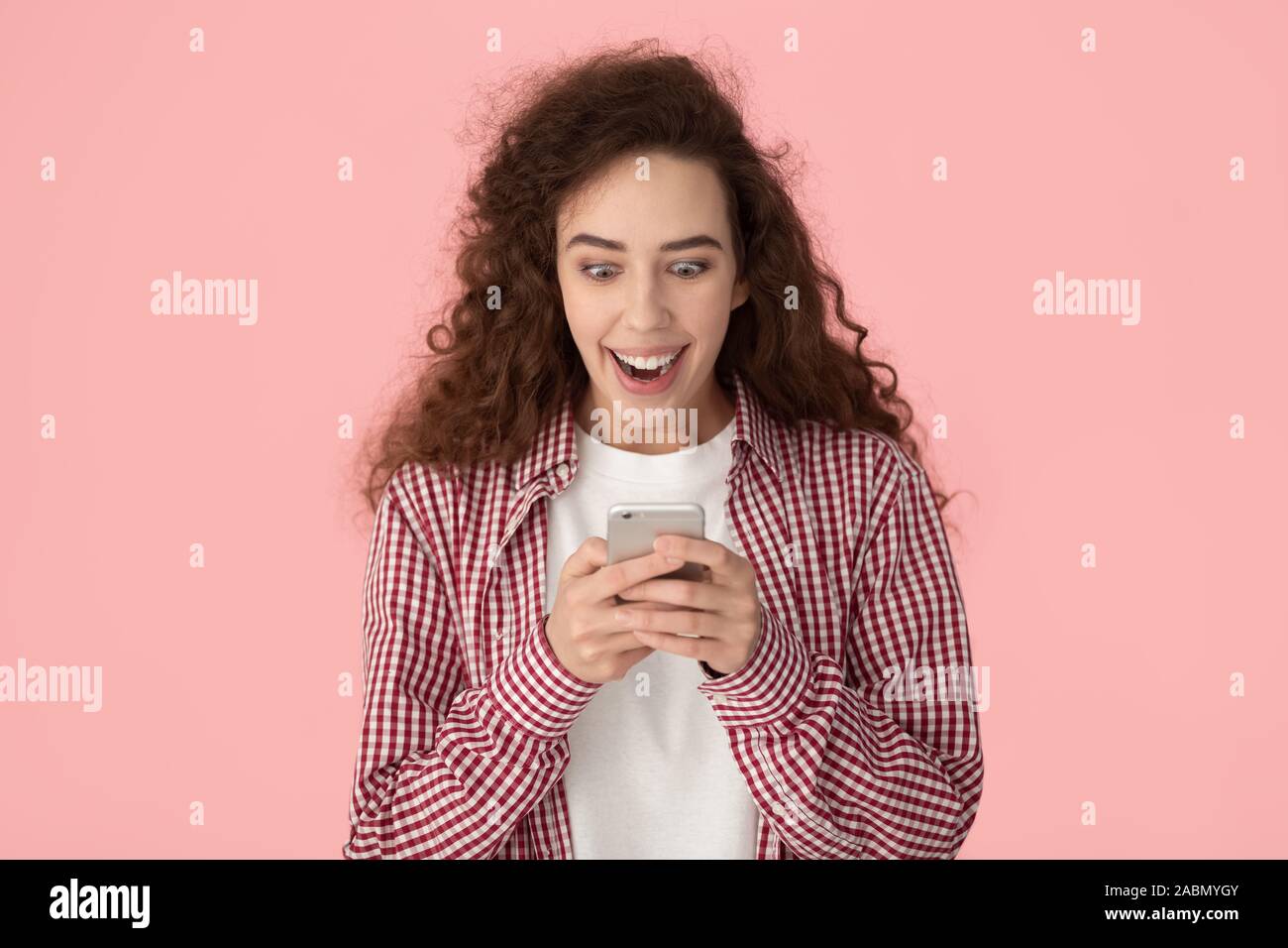Happy millennial girl overjoyed with good message on smartphone Stock ...