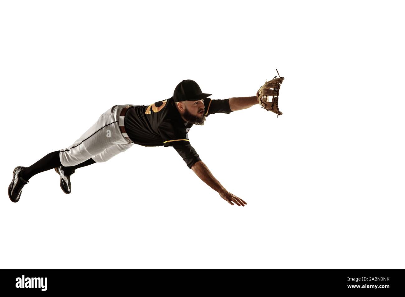 In flight. Baseball player, pitcher in black uniform practicing and ...