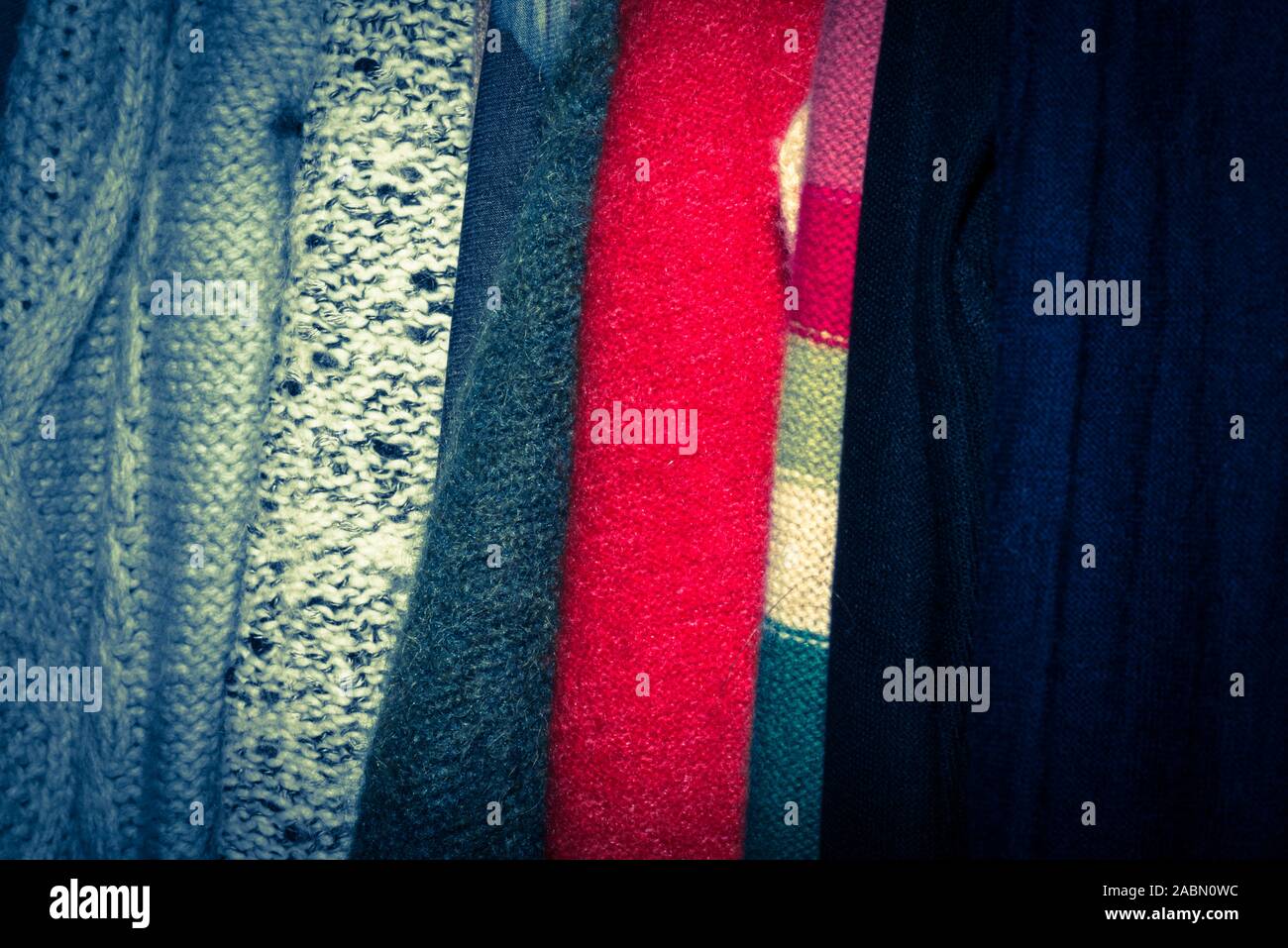 Retro photo of dark silver, blue and red clothing items in a wardrobe ...
