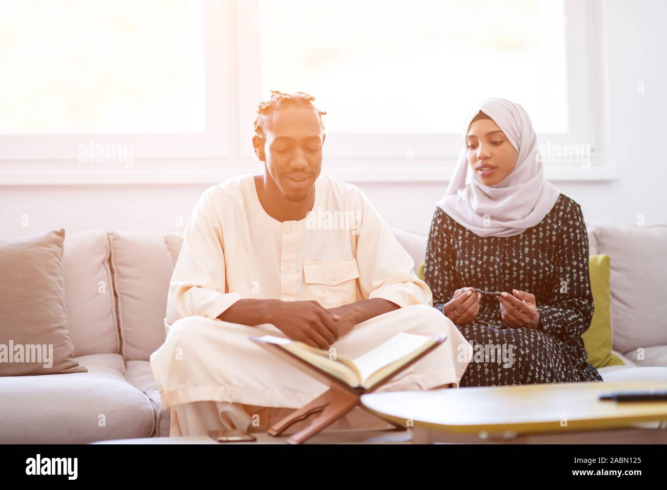 african muslim couple at home in ramadan reading quran holly islam book ...