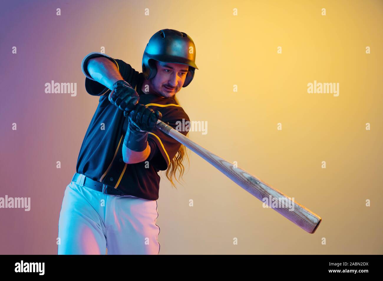 Baseball player, pitcher in a black uniform posing confident on ...