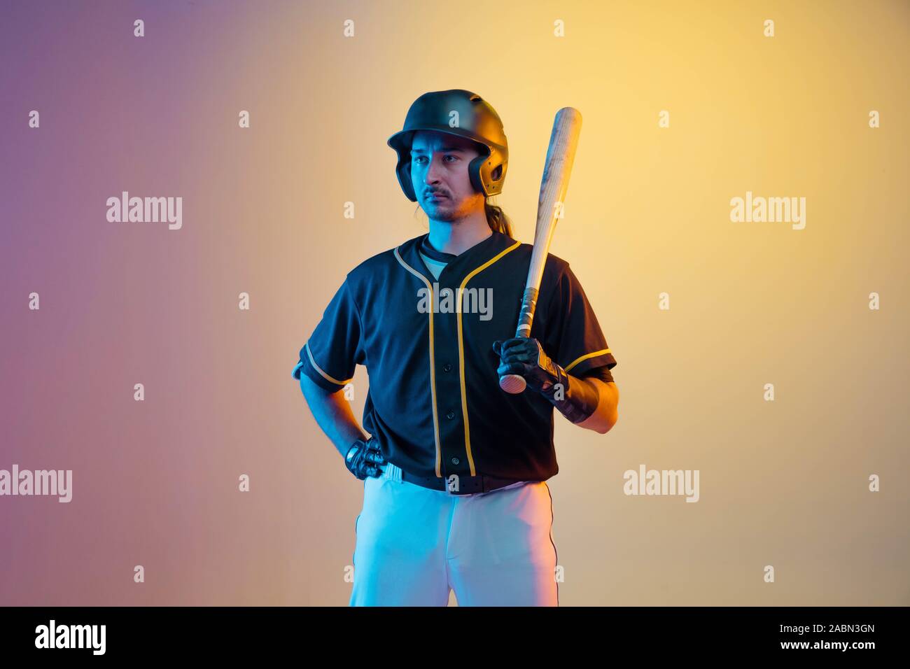 Baseball player, pitcher in a black uniform posing confident on ...