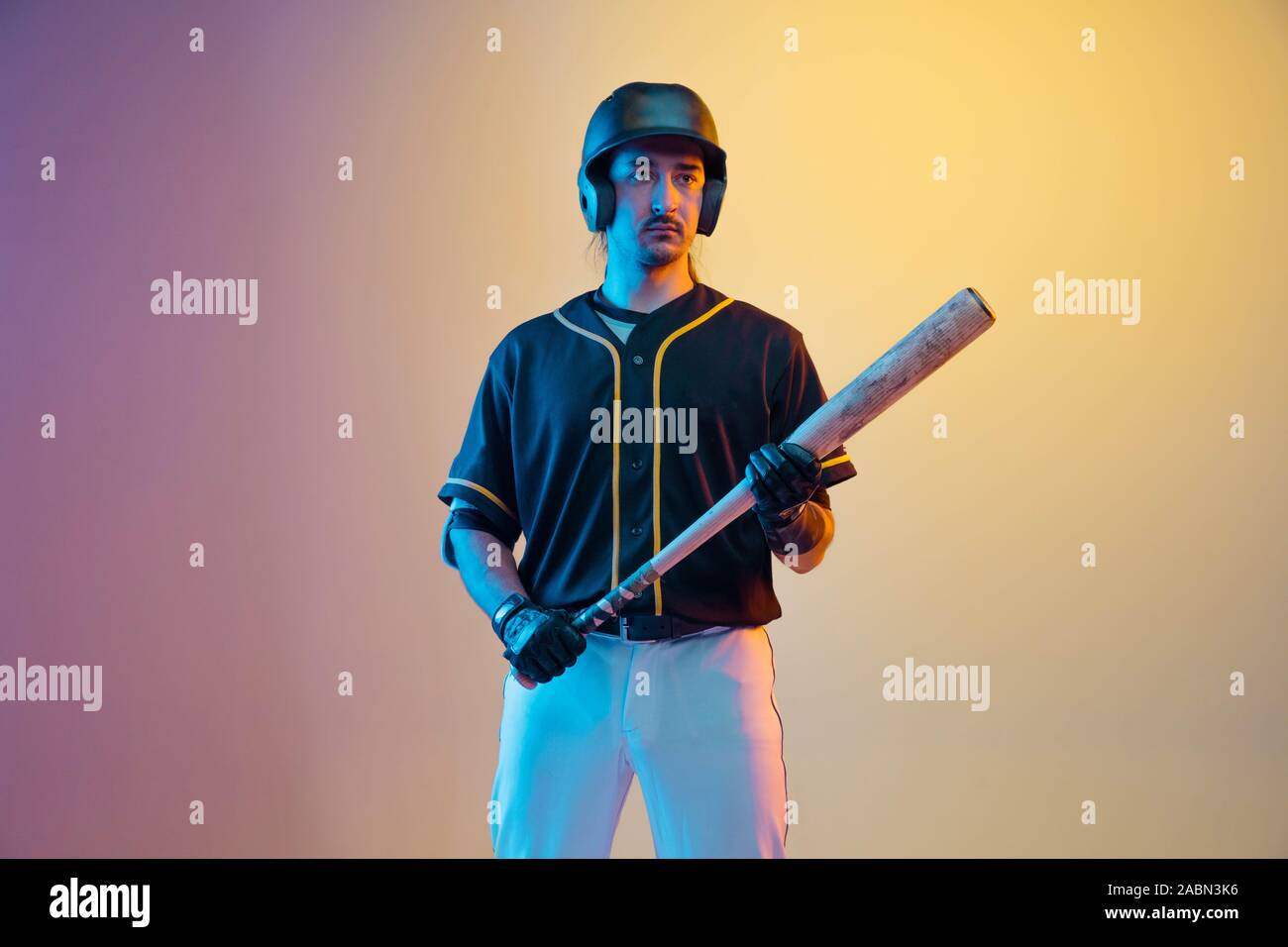Baseball player, pitcher in a black uniform posing confident on ...