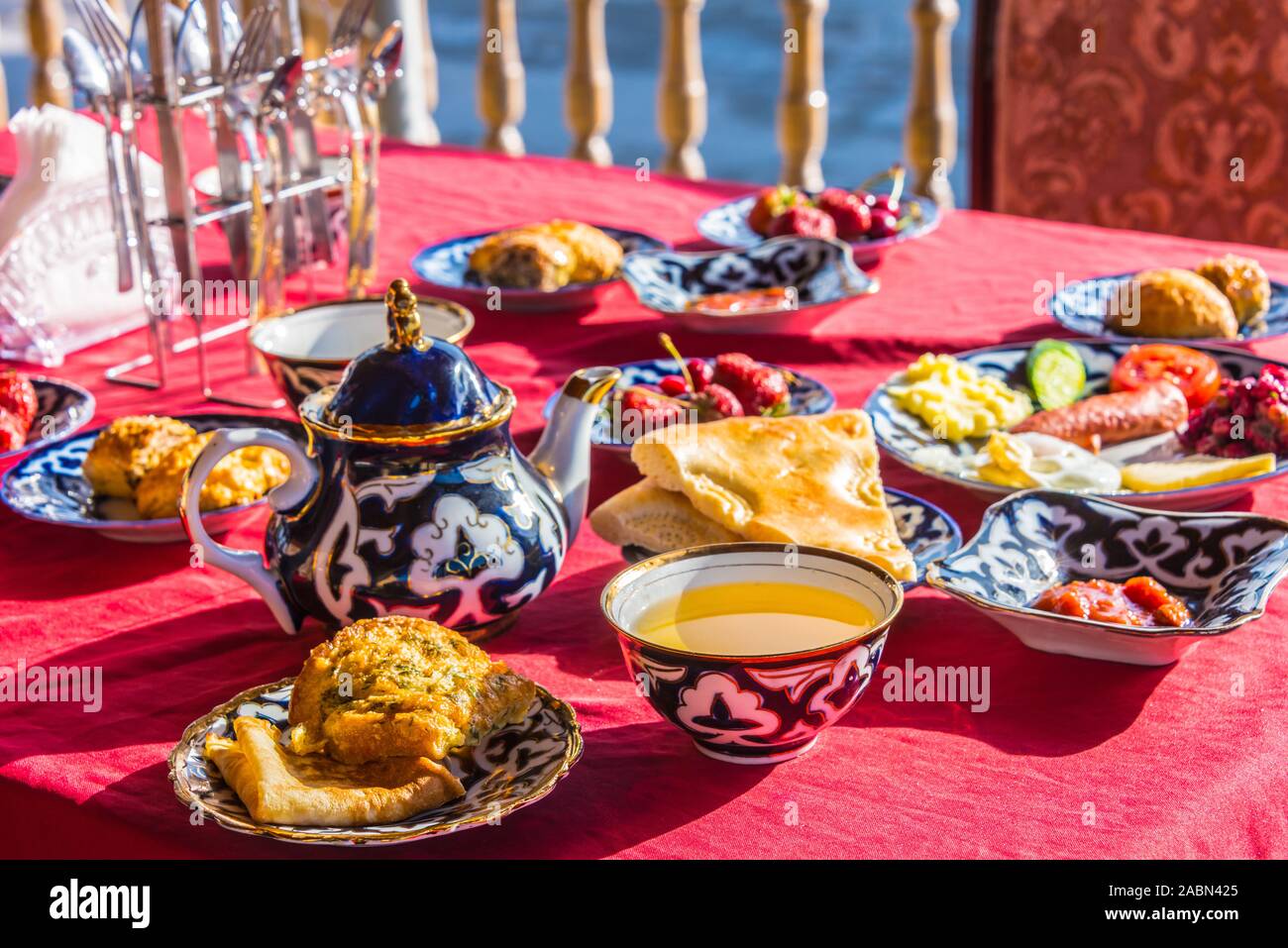 Traditional Uzbek breakfast served on the terrace Stock Photo - Alamy