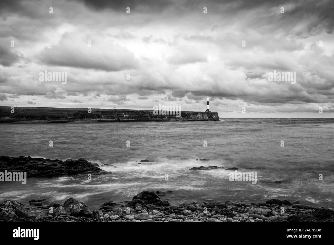 The stone jetty with beacon in black & white, Aberystwyth Ceredigion ...