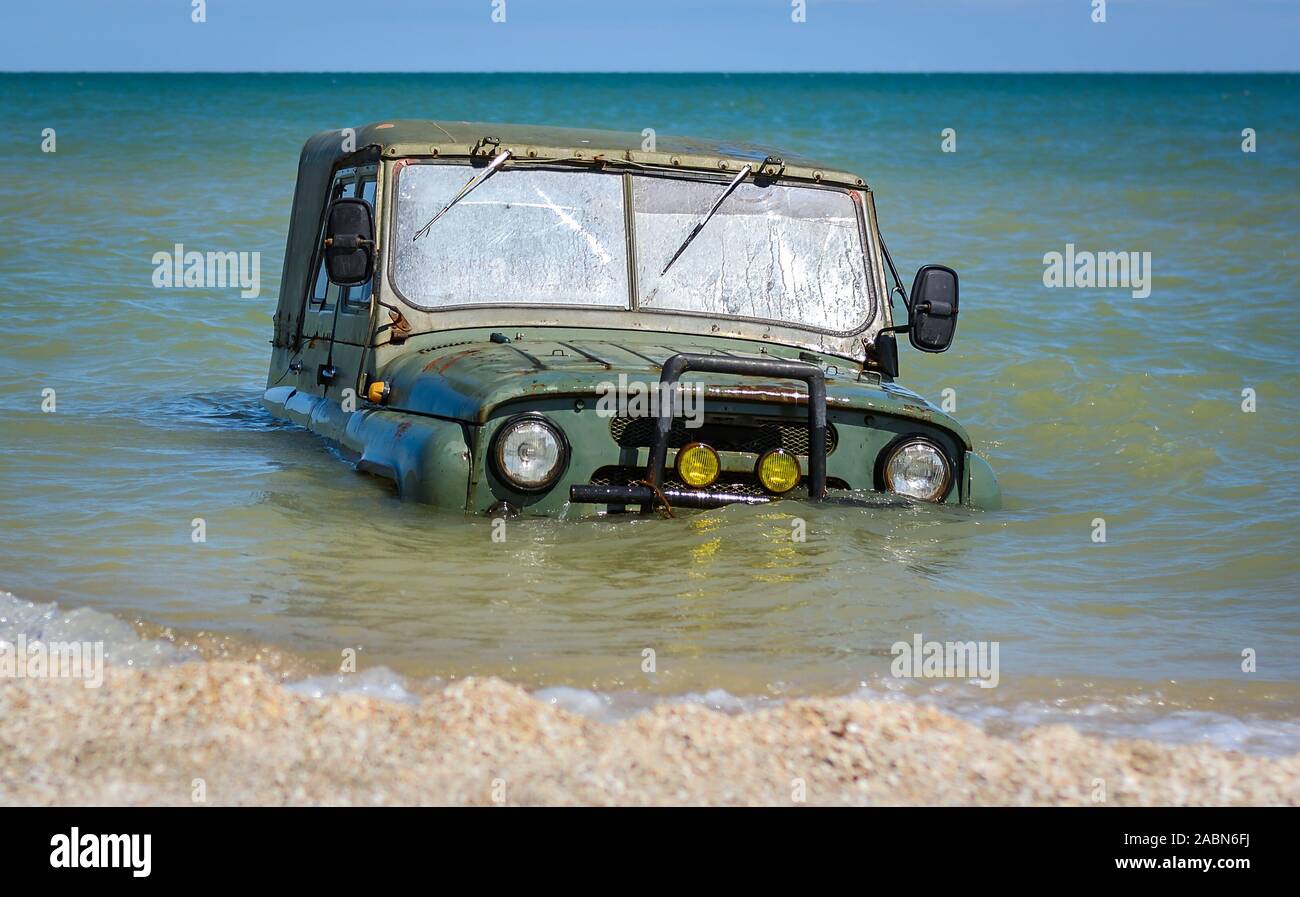 car stuck mud or submerged in sea water on beach ocean or sea Stock ...