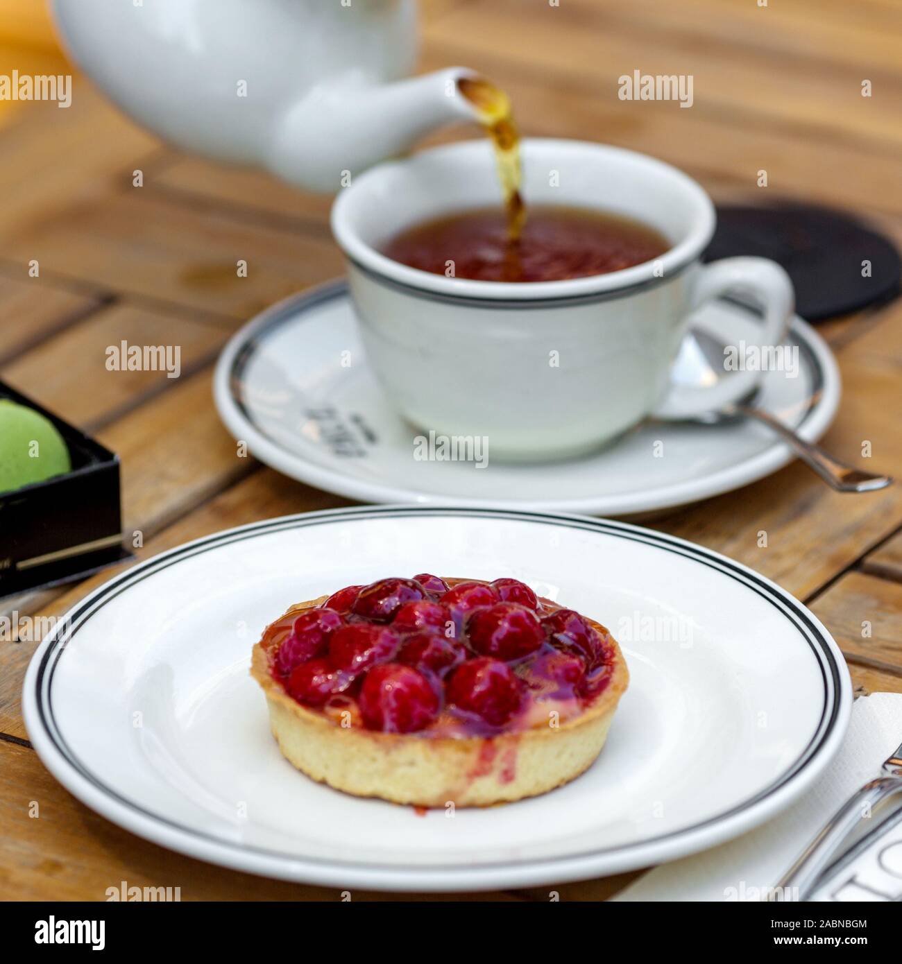 shortcrust pastry dessert with berries and a cup of aromatic tea Stock ...