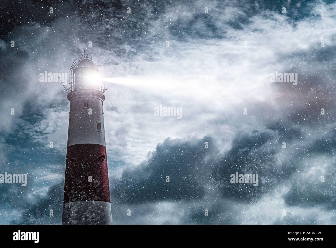 Large red and white lighthouse on a rain and storm filled night with a ...