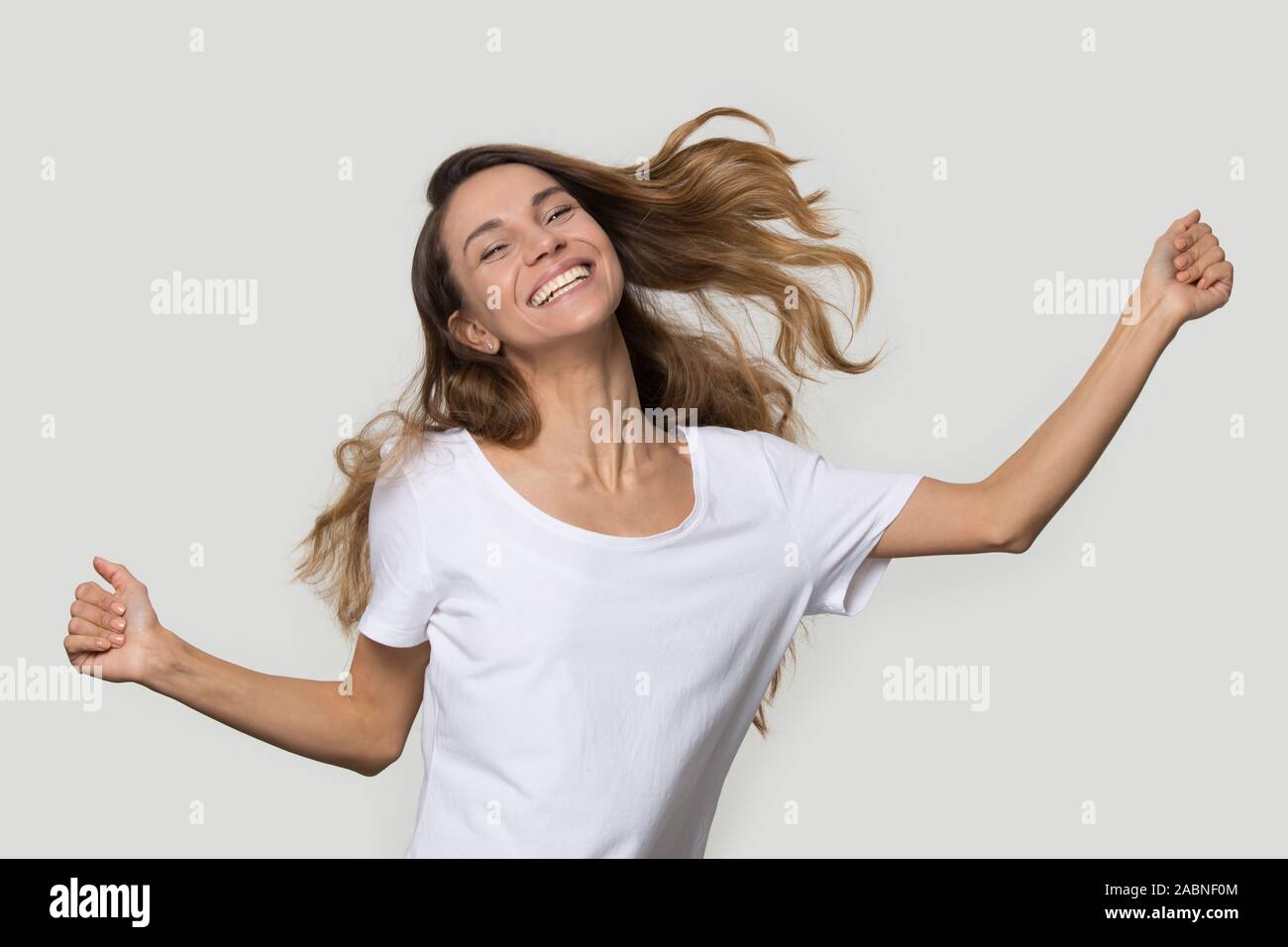 Happy young woman dancing, feeling excited, jumping, having fun Stock ...