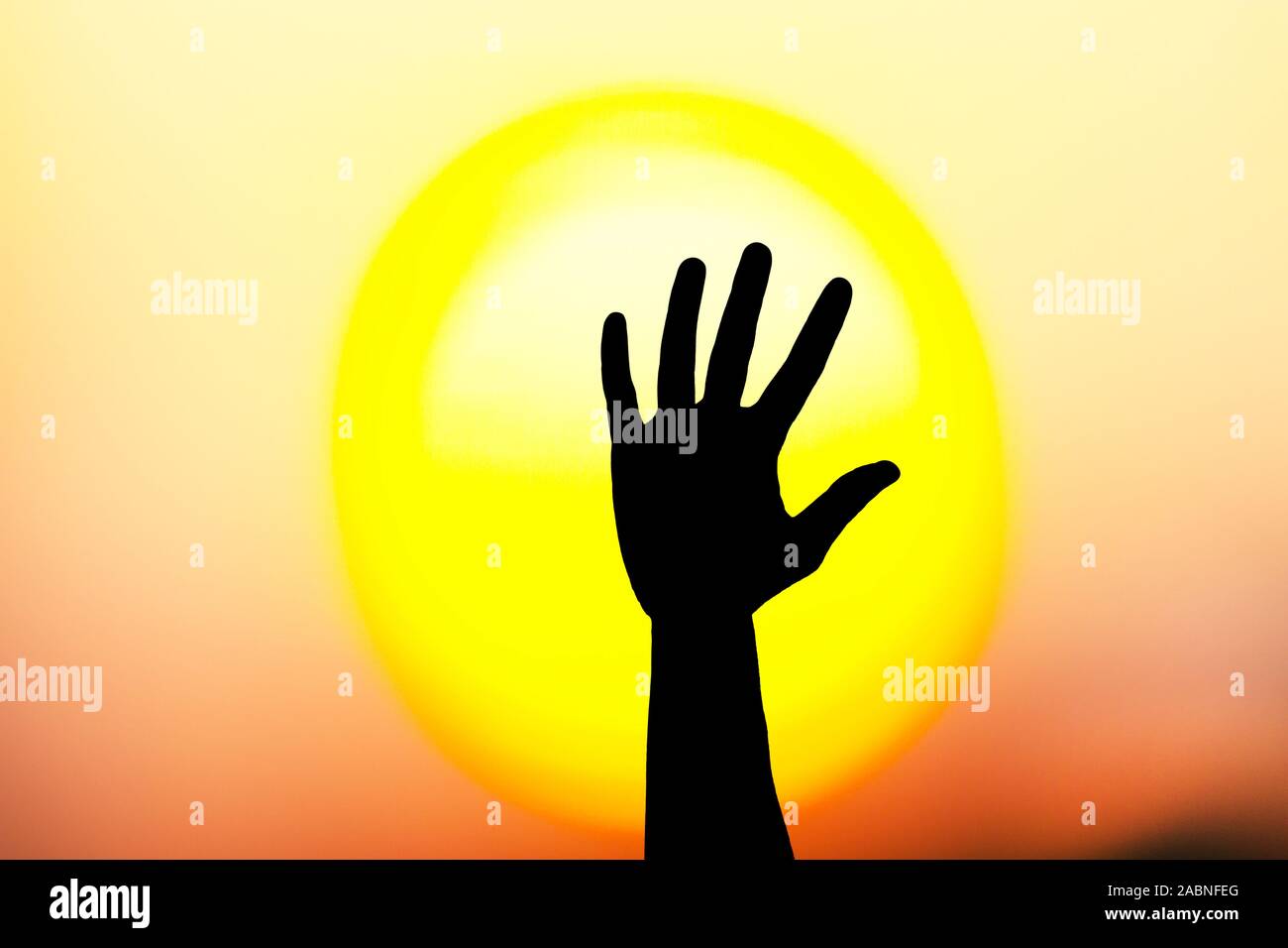 One hand against sun background Stock Photo - Alamy