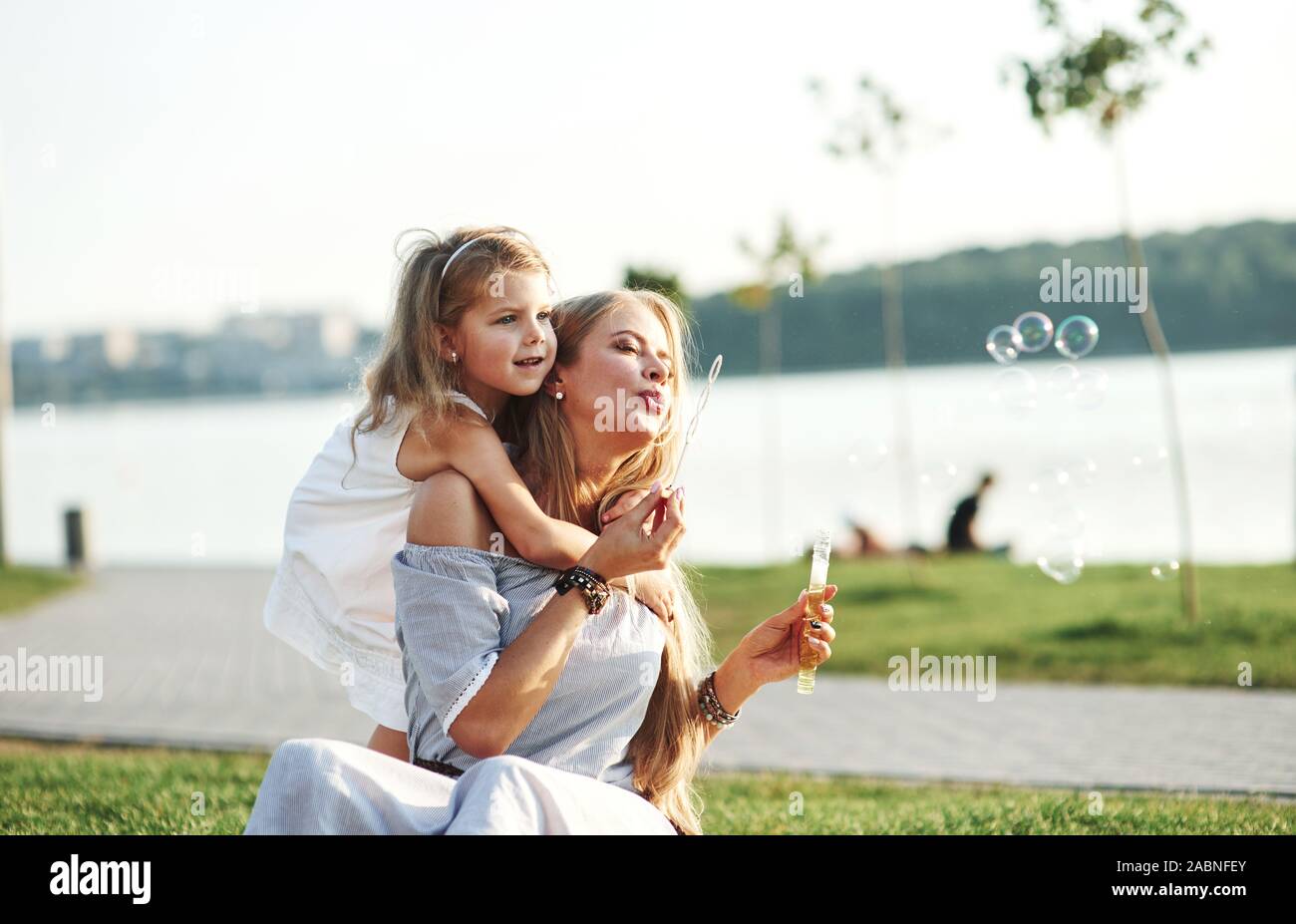 Little child keeps wondering. Photo of young mother and her daughter ...