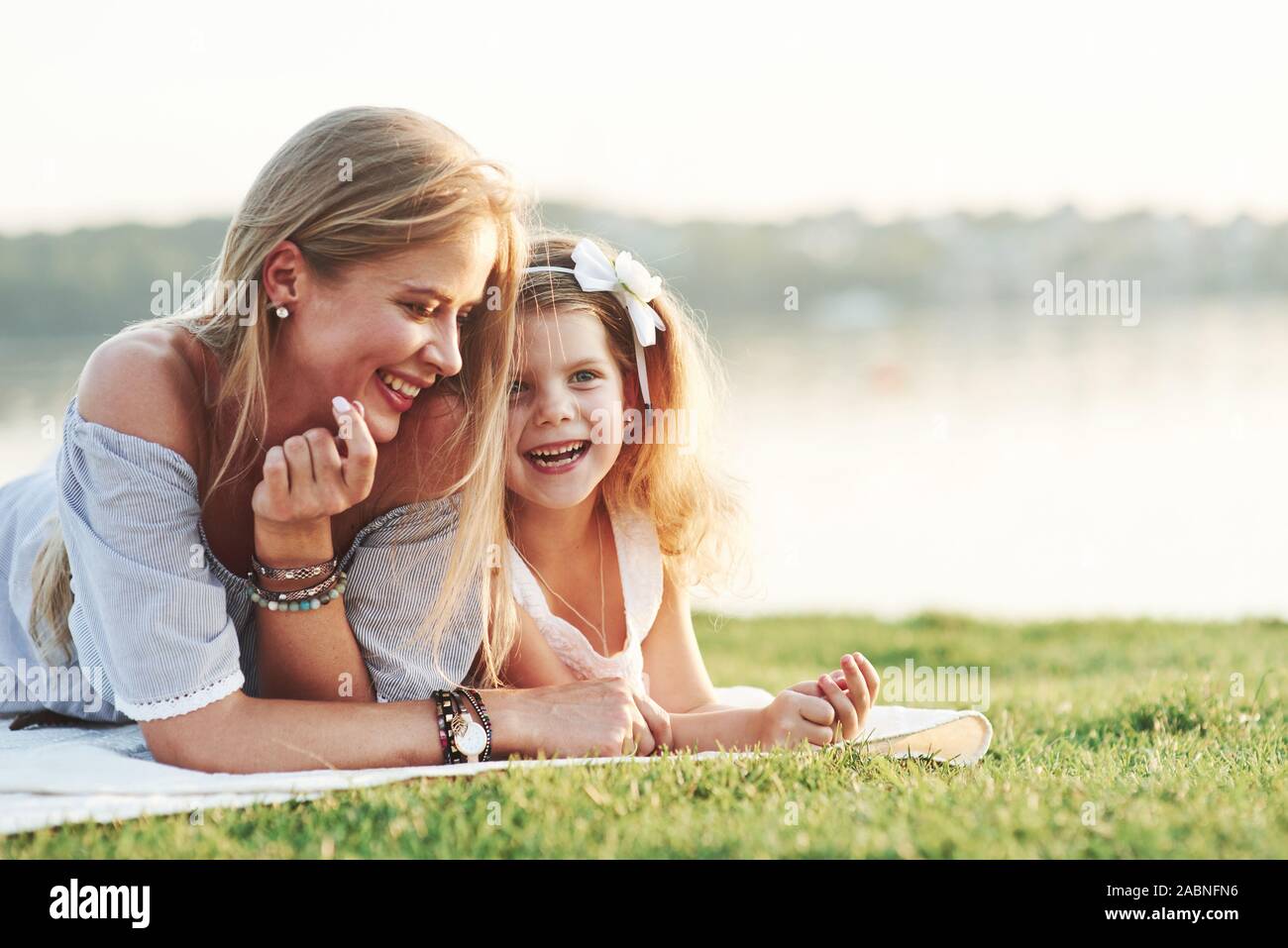 Just heard a joke. Smiling. Photo of young mother and her daughter ...