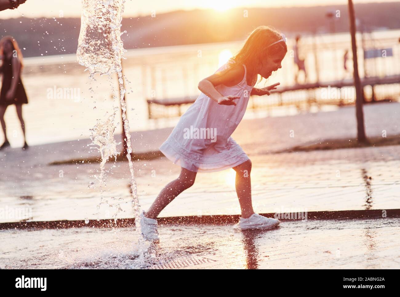 Girl running water fountain hi-res stock photography and images - Alamy