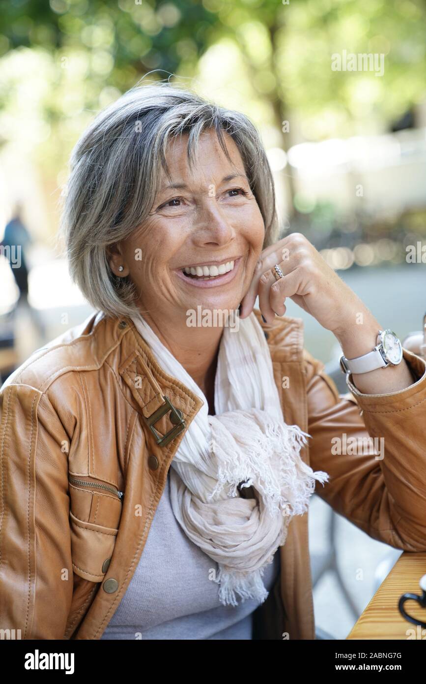 Portrait of smiling active senior woman at coffee shop Stock Photo - Alamy