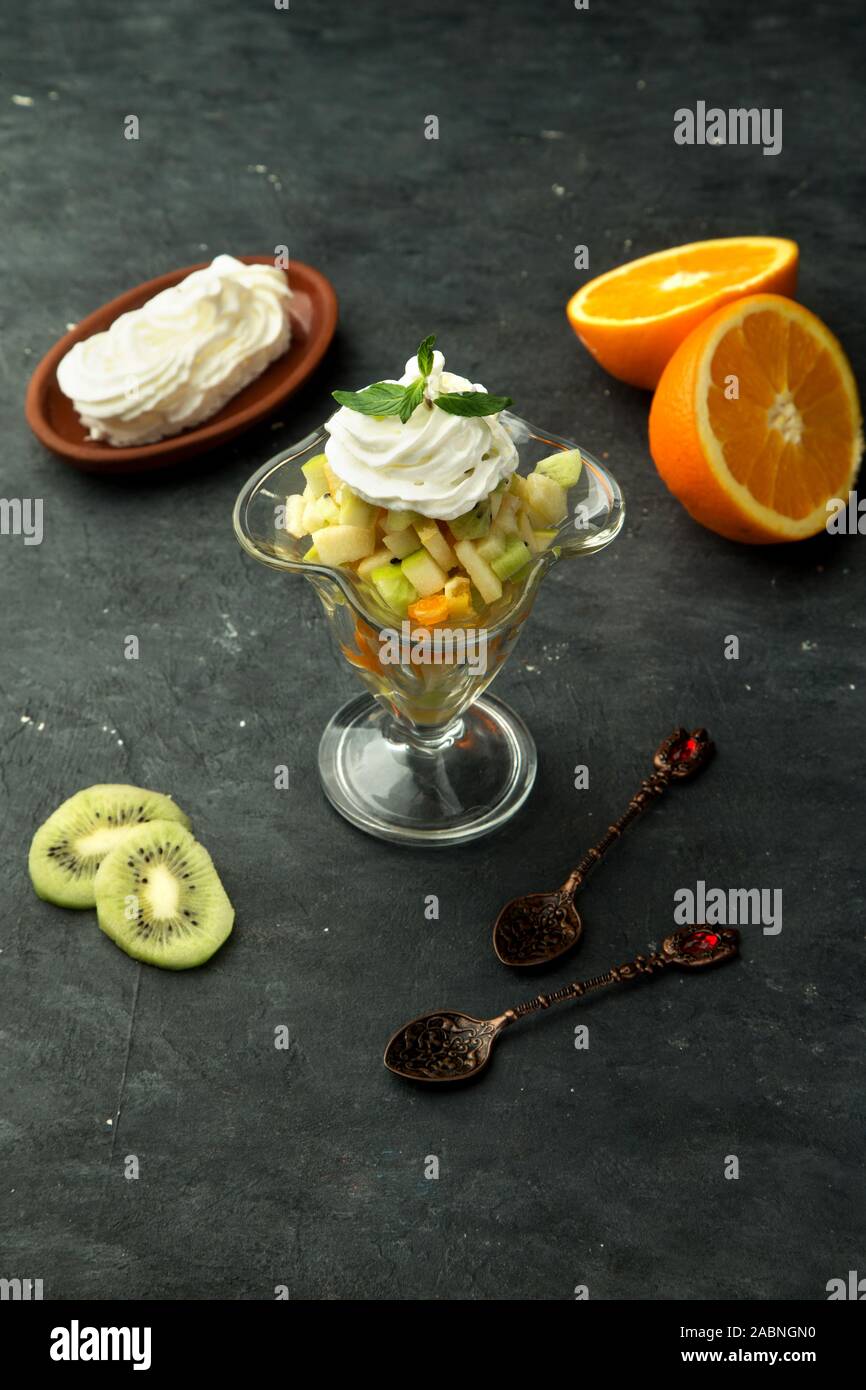 a glass of mixed fruit with cream Stock Photo - Alamy