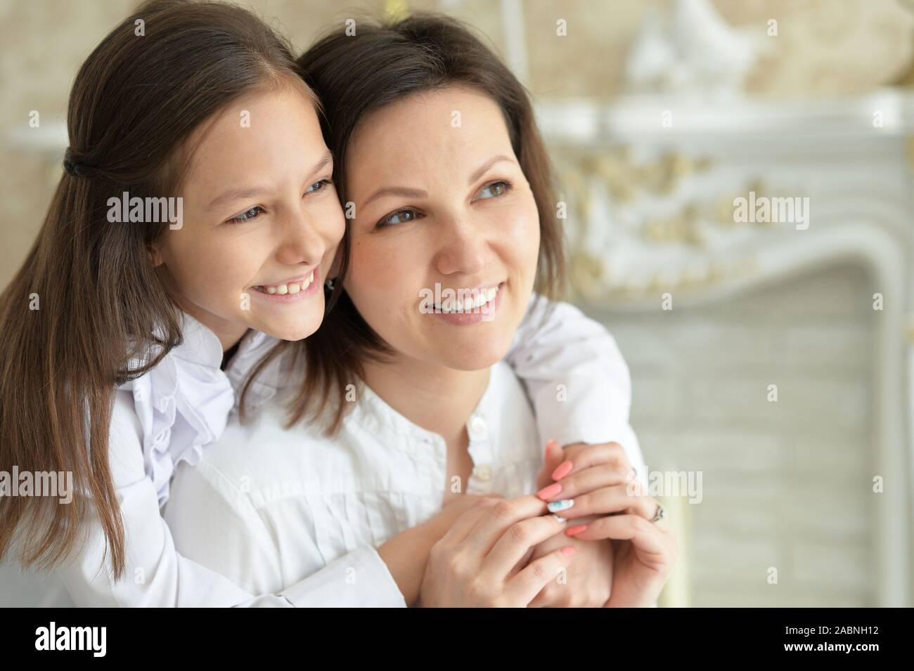 Beautiful young mother and cute little daughter posing Stock Photo - Alamy