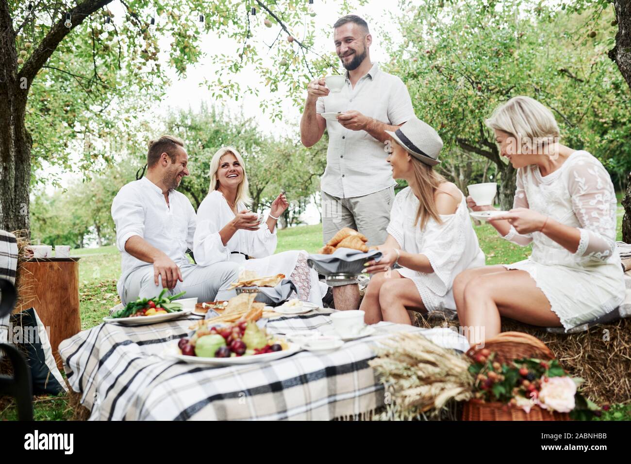 Family relaxing in garden lights hi-res stock photography and images ...