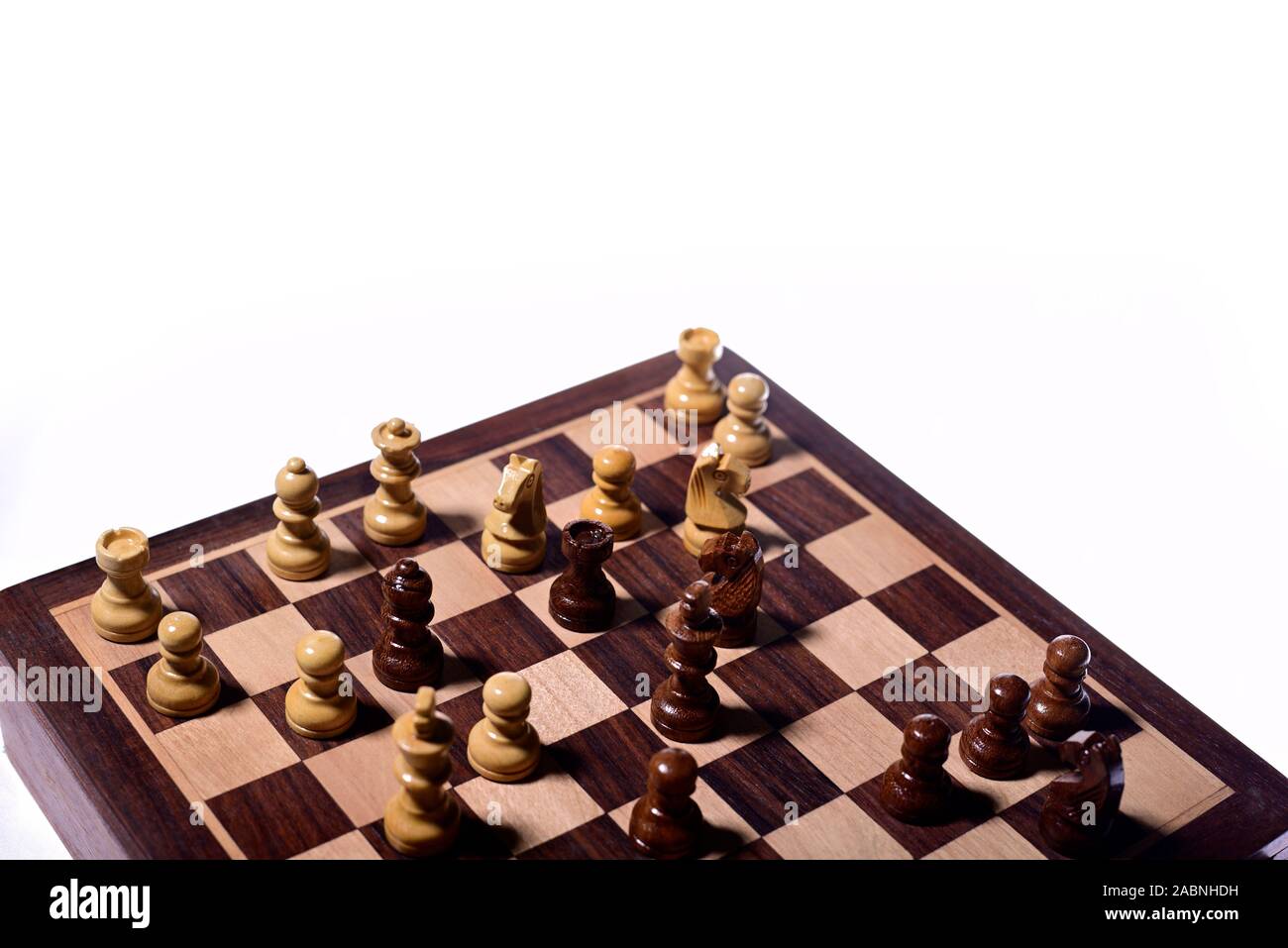 Top angle shot of chess pieces on chessboard against white background ...