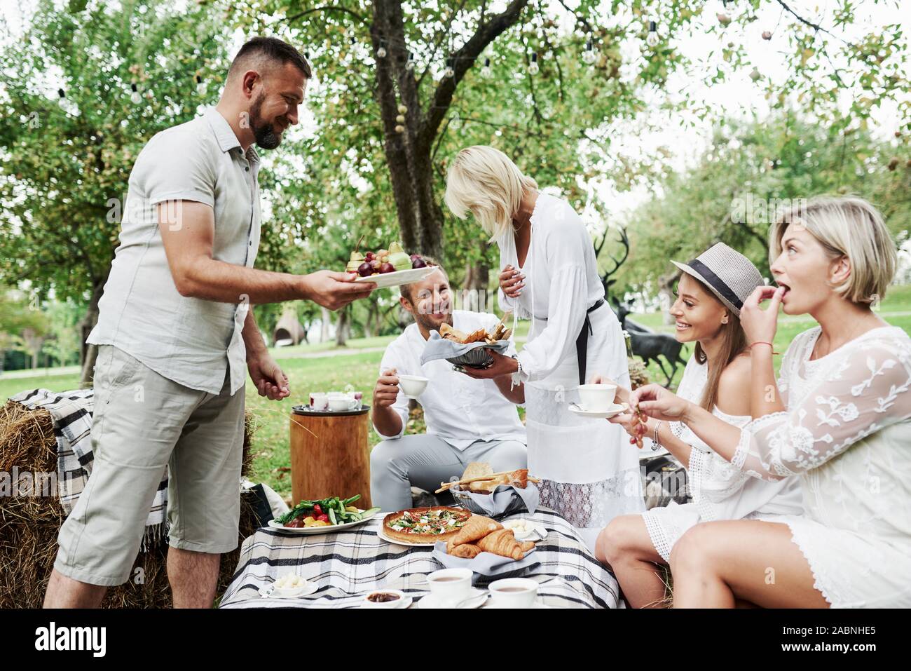 Family relaxing in garden lights hi-res stock photography and images ...