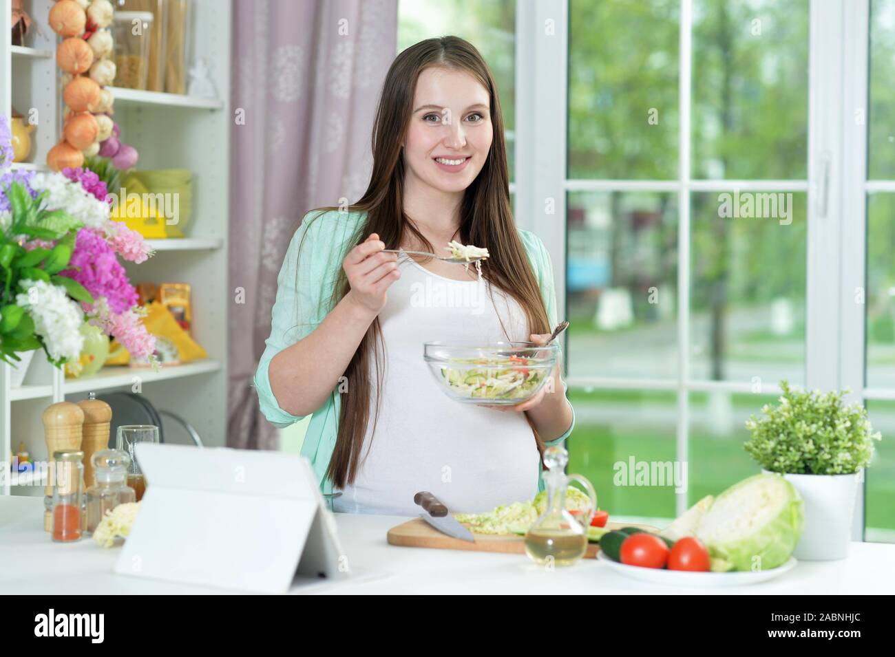 Portrait ofa beautiful young woman cooking in kitchen Stock Photo - Alamy
