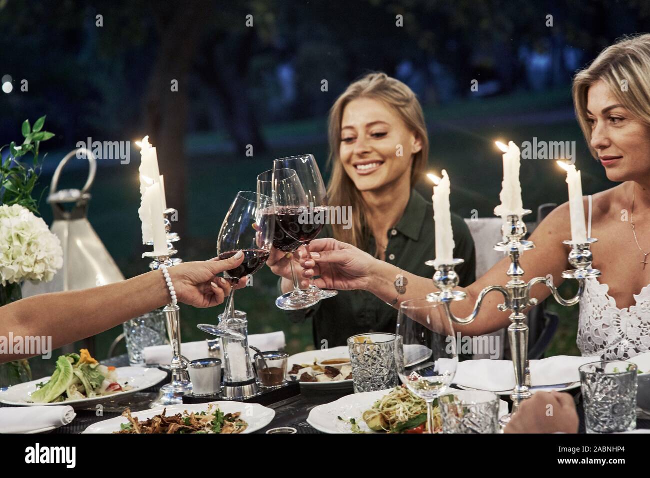 Family relaxing in garden lights hi-res stock photography and images ...