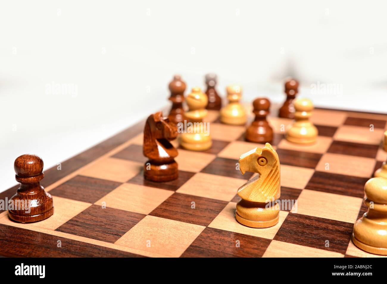 Top angle shot of chess pieces on chessboard against white background ...