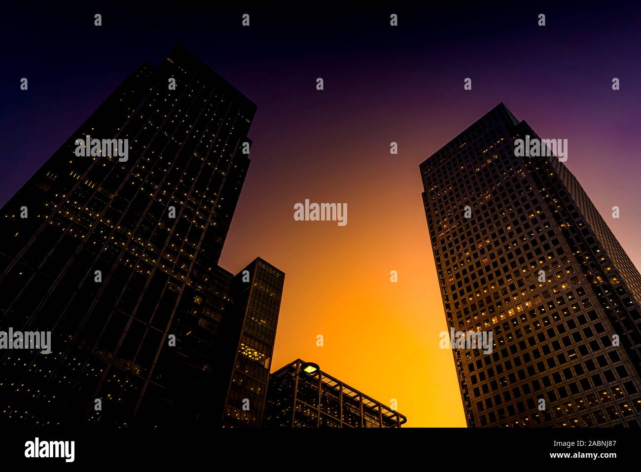 Modern city sky scrapers with glass fronts on a clear day at sunset in ...