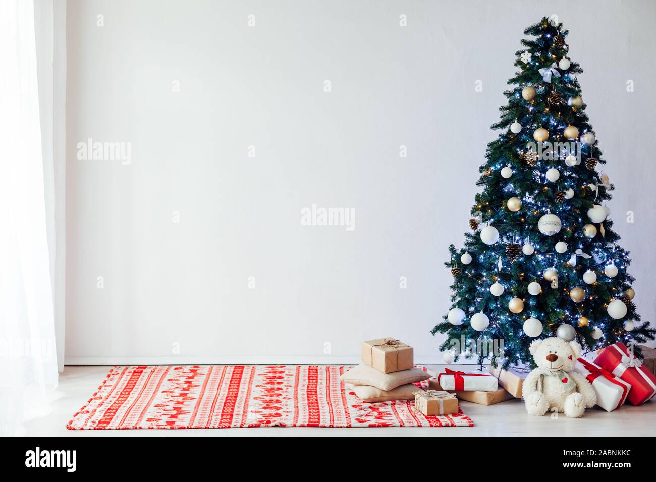 Christmas tree with gifts decor in the interior of the white room as a ...