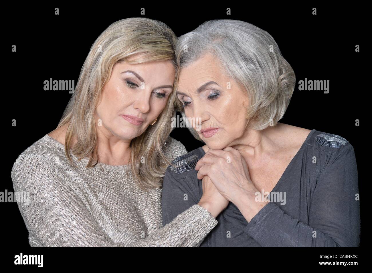 Portrait of a two sad women posing Stock Photo - Alamy