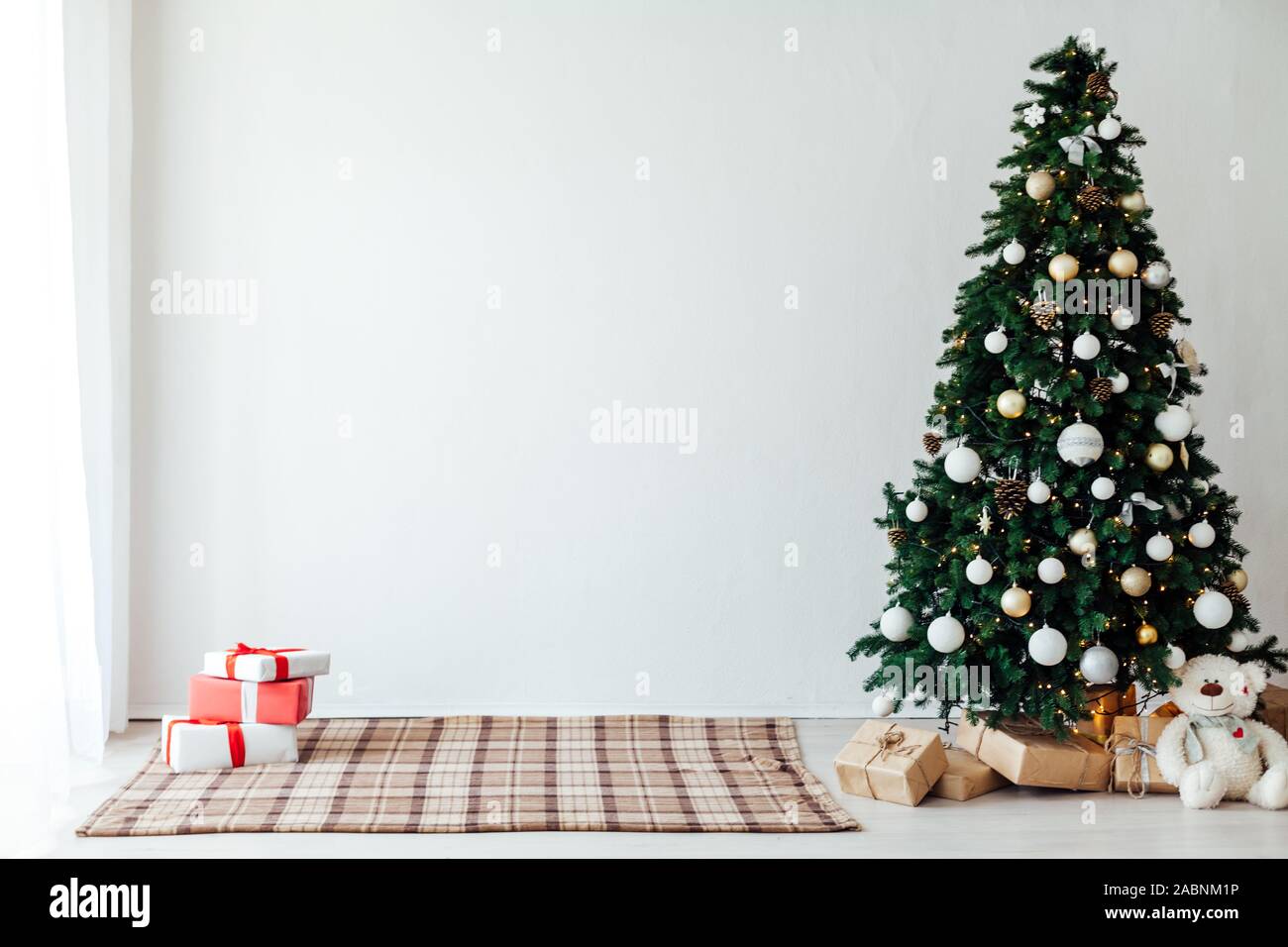 Christmas tree with gifts decor in the interior of the white room as a ...