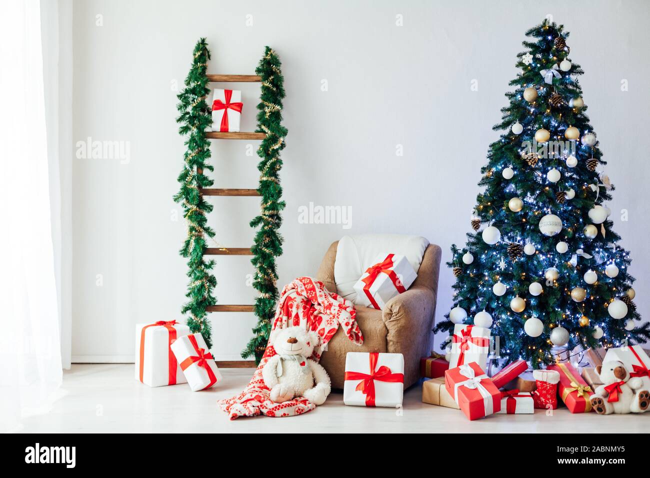 Christmas tree with gifts Of December decor in the interior of the ...
