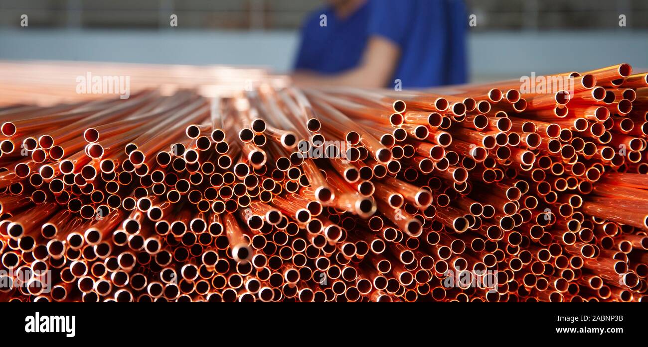 Copper pipes in factory, industrial background. Metal workers in ...